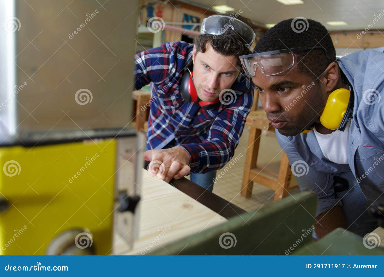 Carpenter Training Male Apprentice To Use Mechanized Saw Stock Image ...