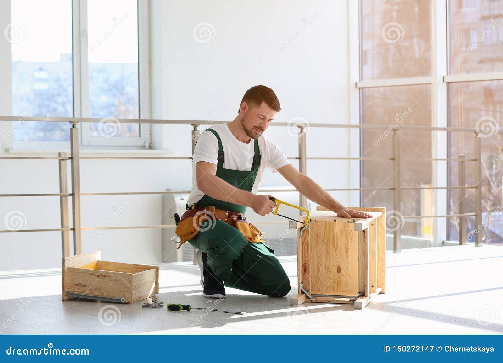 Carpenter in Uniform Making Furniture. Professional Construction Tools ...