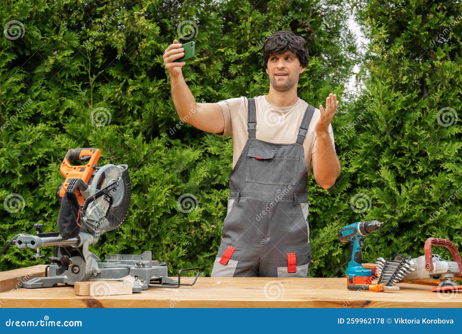 Carpenter Using Camcorder in Workshop. Caucasian Male Craftsperson with ...