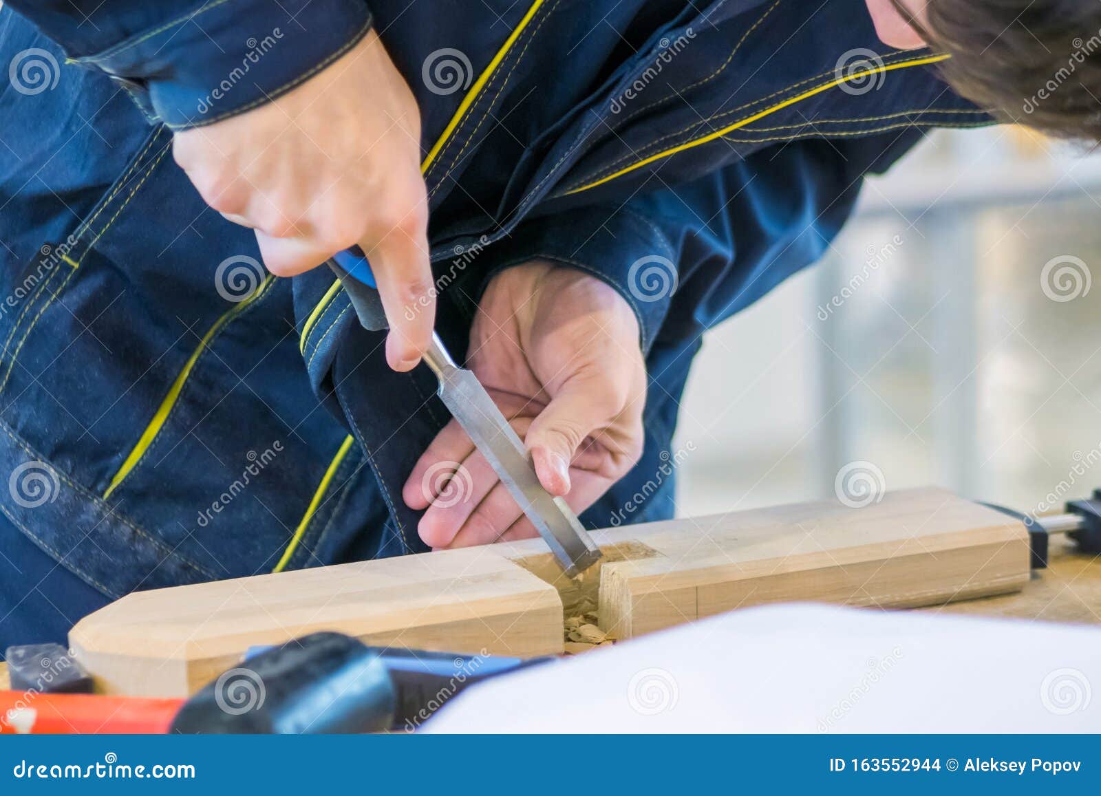Carpenter Using Chisel To Carve Wood on Rough Workbench at Workshop ...