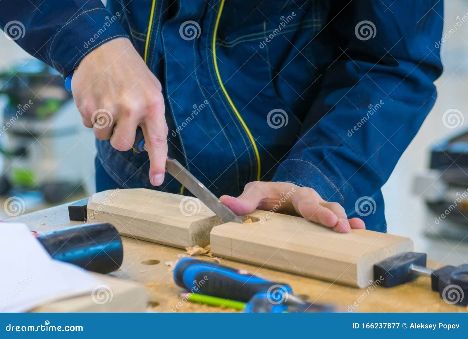 Carpenter Using Chisel To Carve Wood on Rough Workbench at Workshop ...