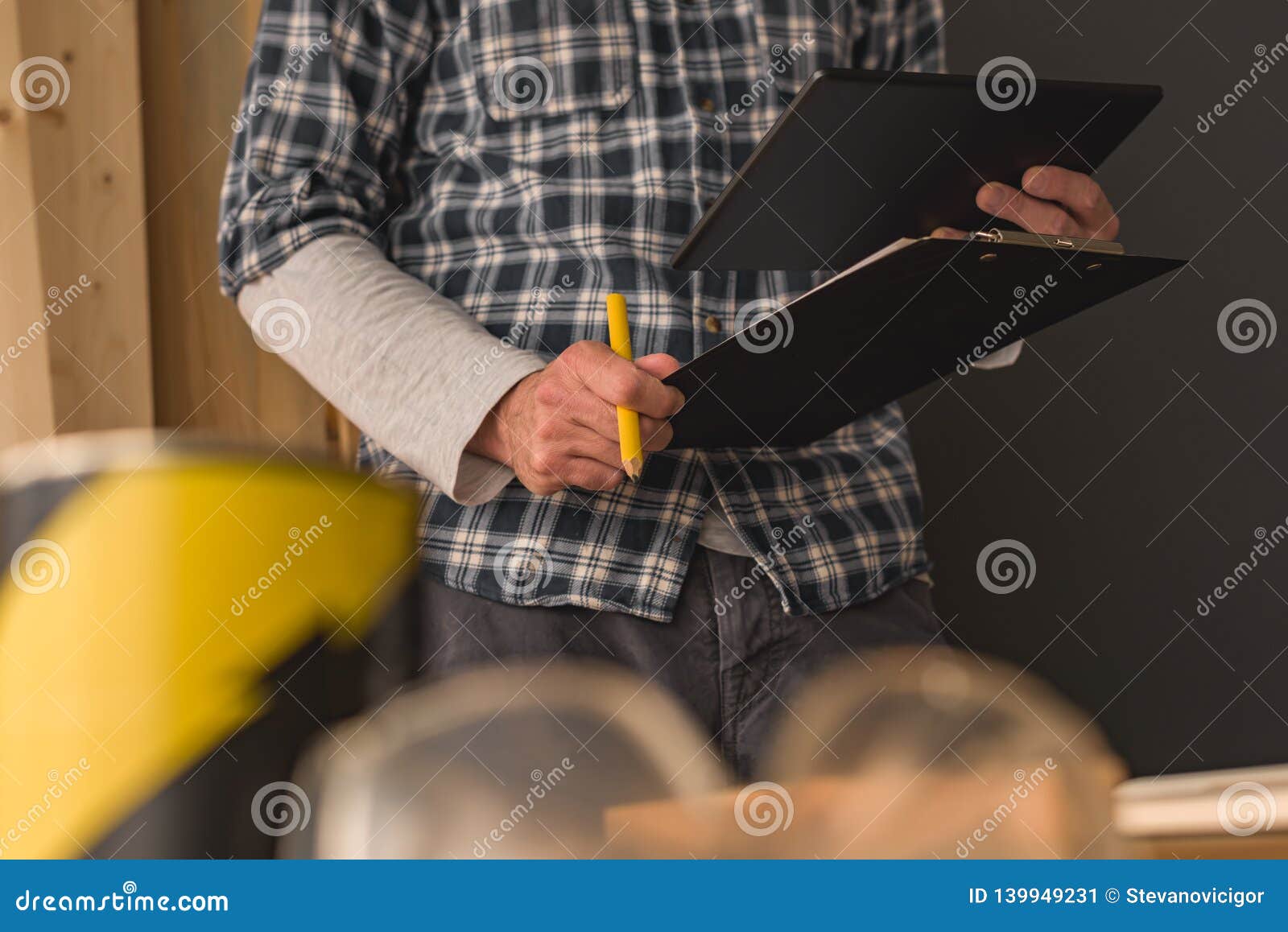 Carpenter Using Digital Tablet and Clipboard Notepad Stock Image ...