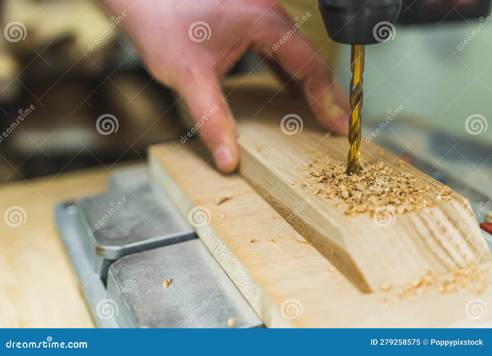 Carpenter Using Drill Machine To Drill Hole on Wooden Plank Placed on ...