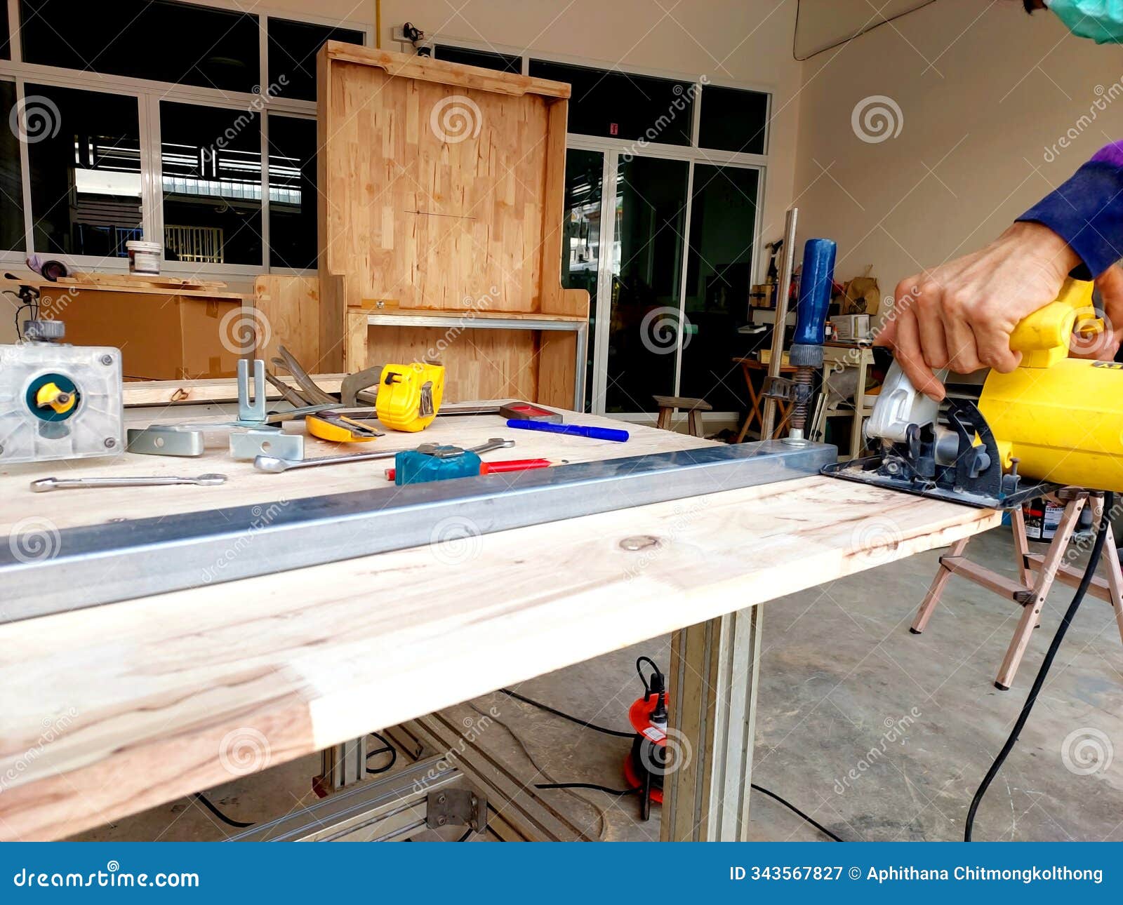 Carpenter Using Electric Hand Circular Saw Cutting Pine Wood Plank ...