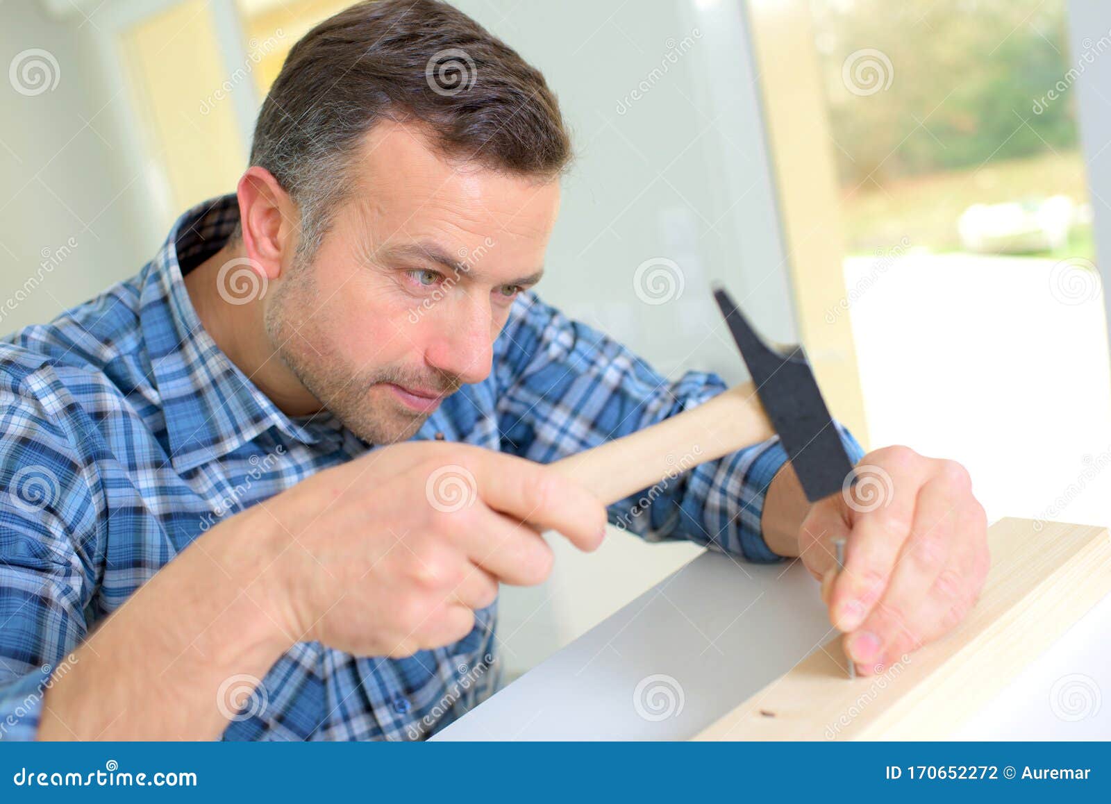 Carpenter using hammer stock photo. Image of builder - 170652272