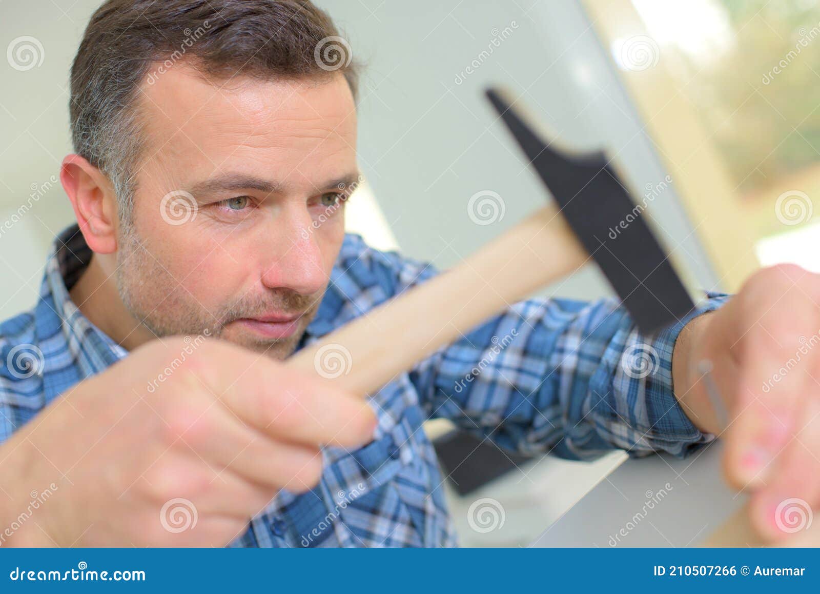 Carpenter using a hammer stock photo. Image of blue - 210507266