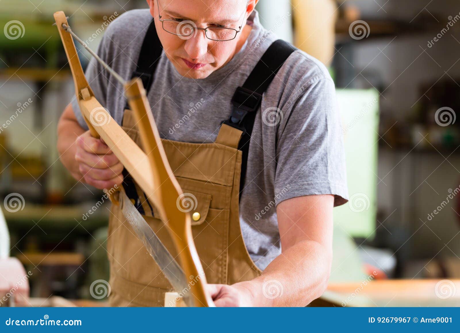 Carpenter using hand saw stock image. Image of occupation - 92679967