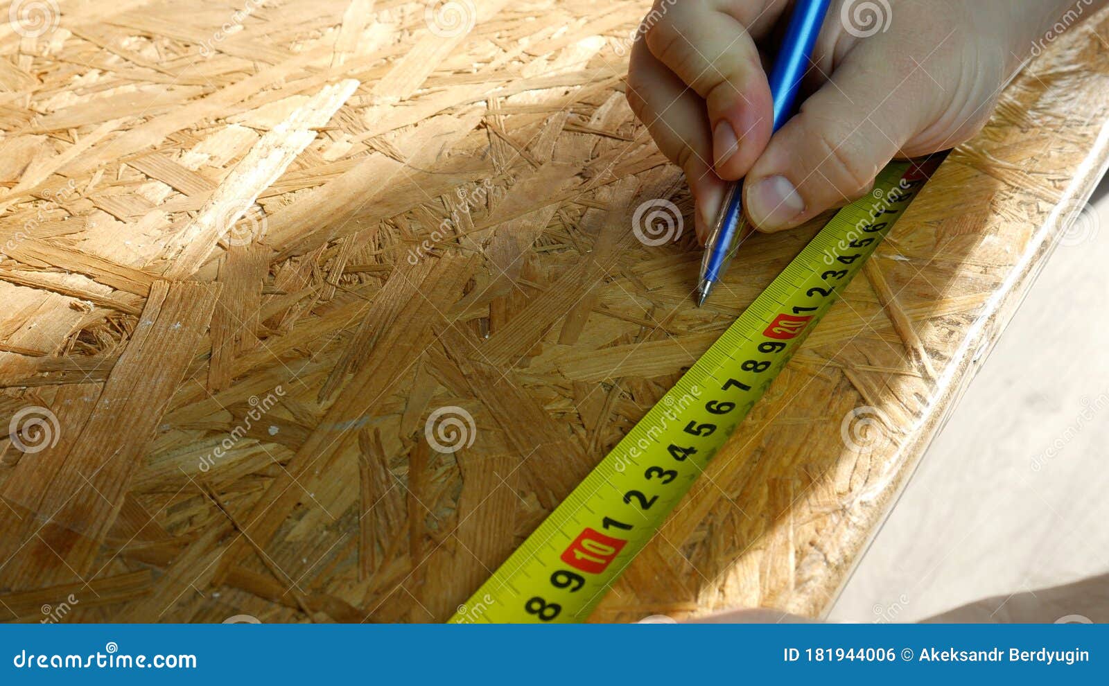 Carpenter Using Measuring Tape To Mark Section of Plywood Stock Photo ...