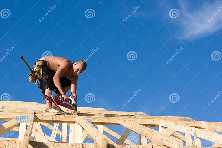 Carpenter Using Nail Gun stock image. Image of blue, home - 11650867