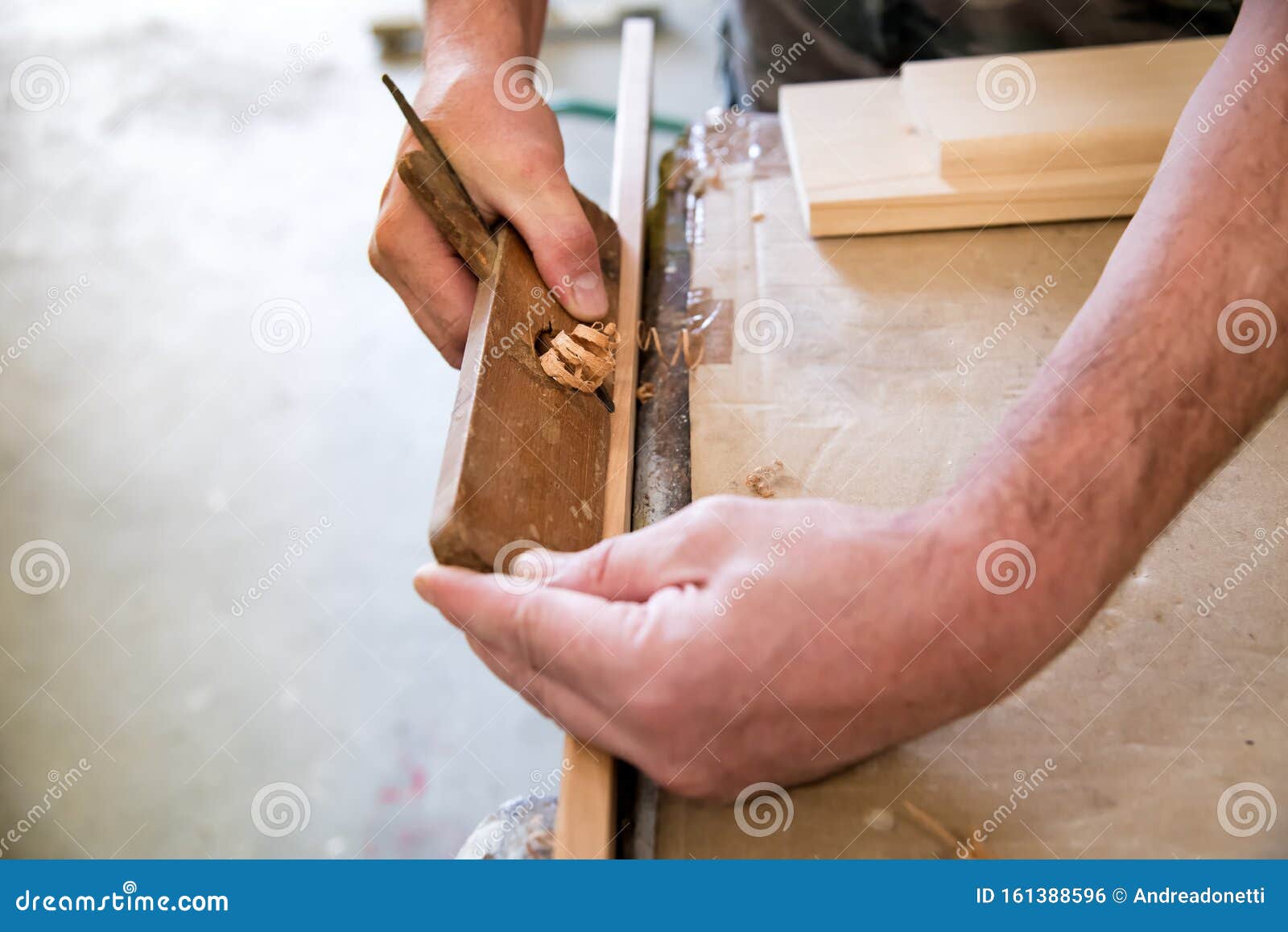 Carpenter Using a Planer on a Plank of Wood Stock Photo - Image of ...