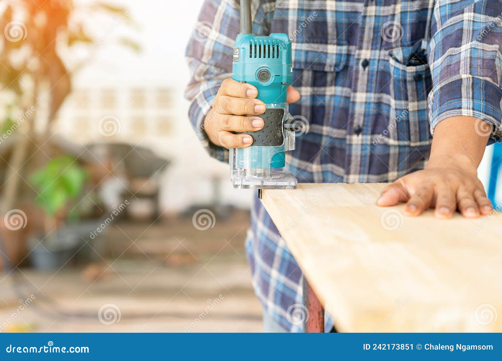 The Carpenter Using a Trimmer To Cut Edging Plank Stock Image - Image ...