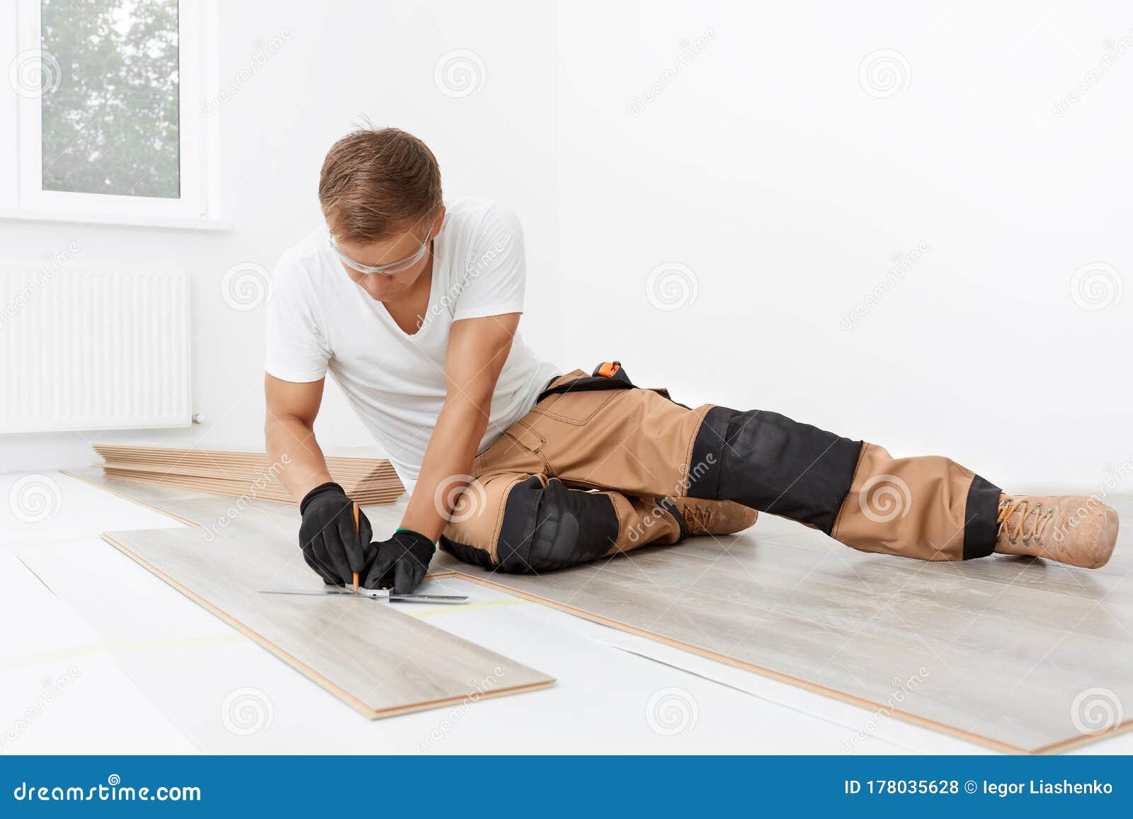 Carpenter Worker Installing Laminate Flooring in the Room Stock Photo ...