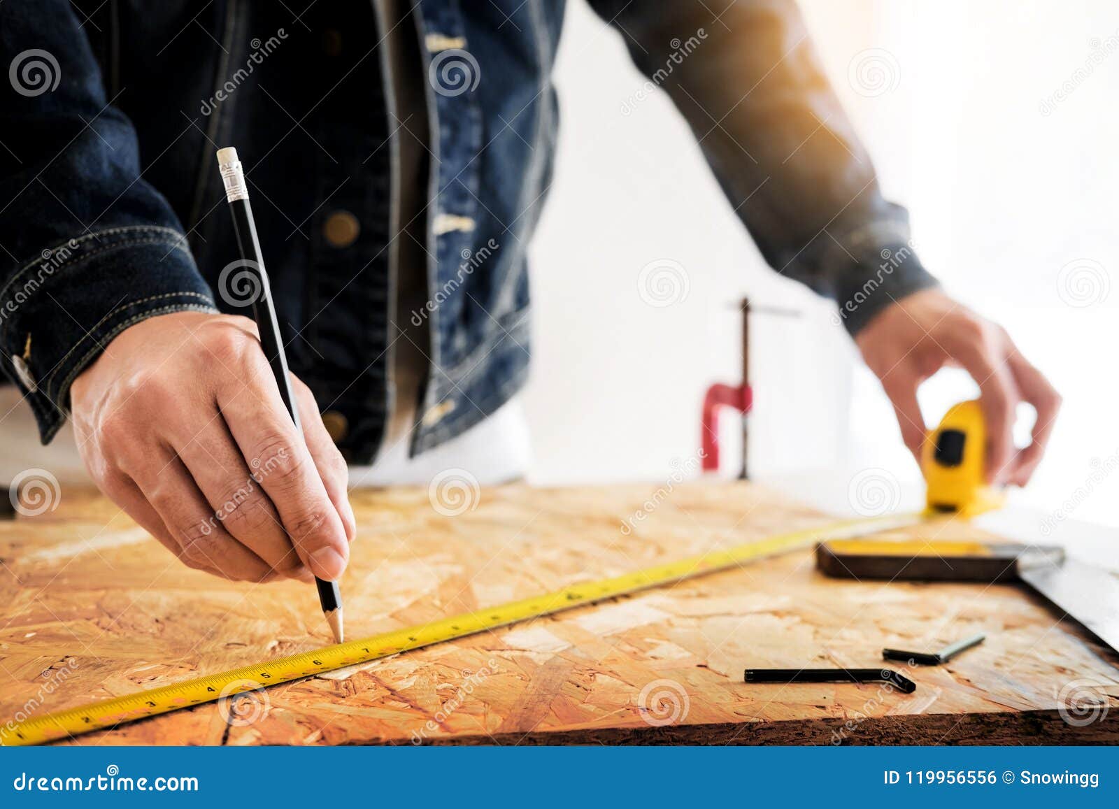 Carpenter Working Carefully Looking at the Plans Work in Carpentry. he ...
