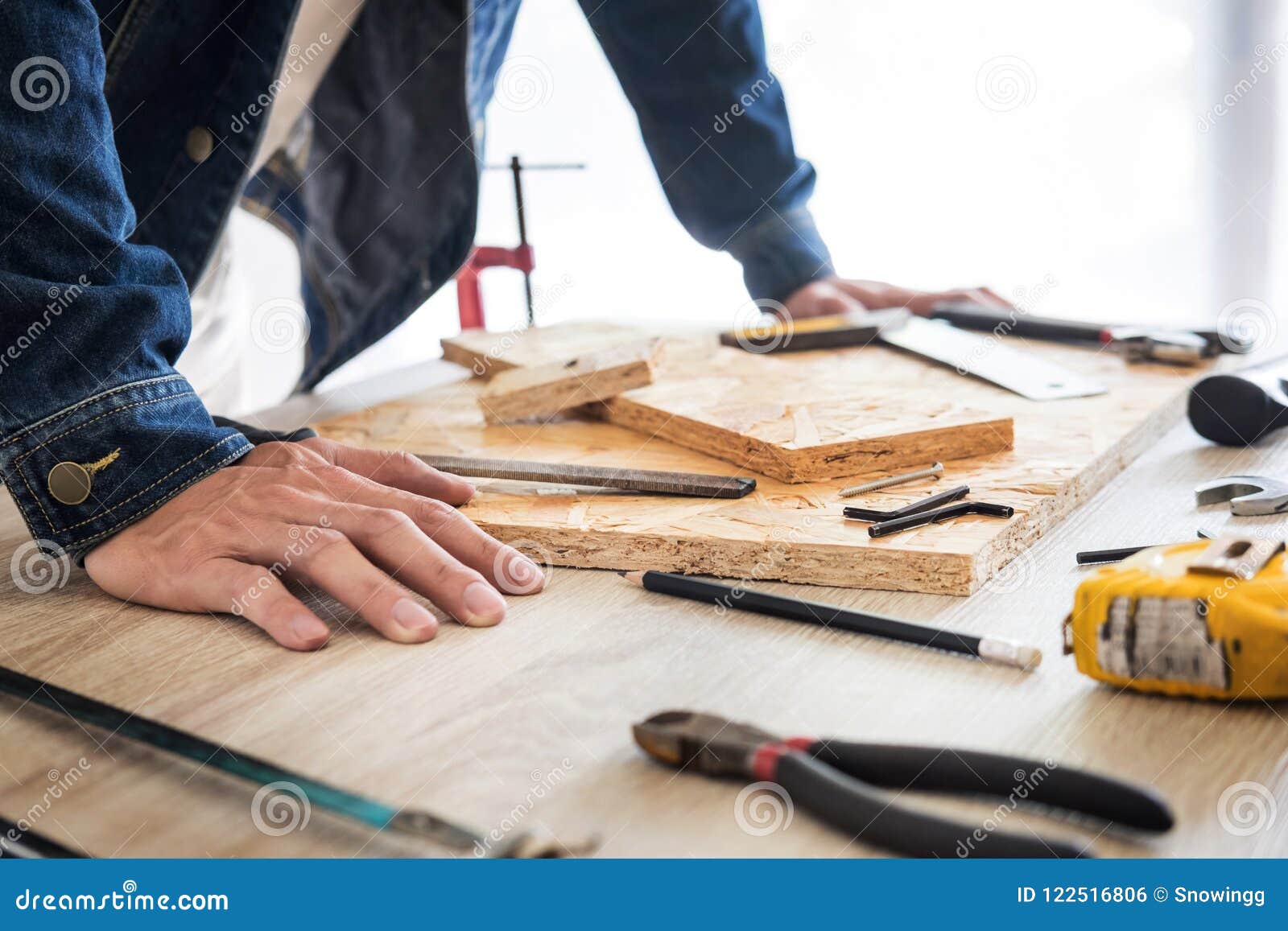 Carpenter Working Carefully Looking at the Plans Work in Carpentry. he ...