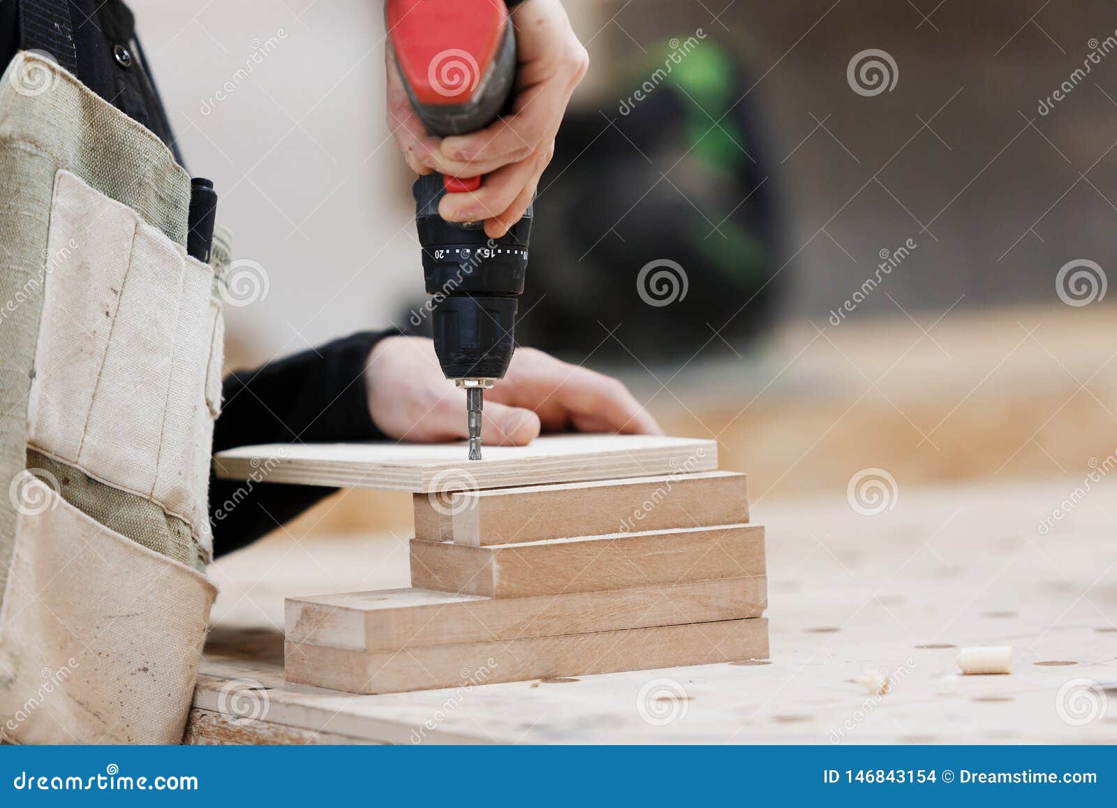 Carpenter Working with an Electric Screwdriver on the Work Bench. Stock ...