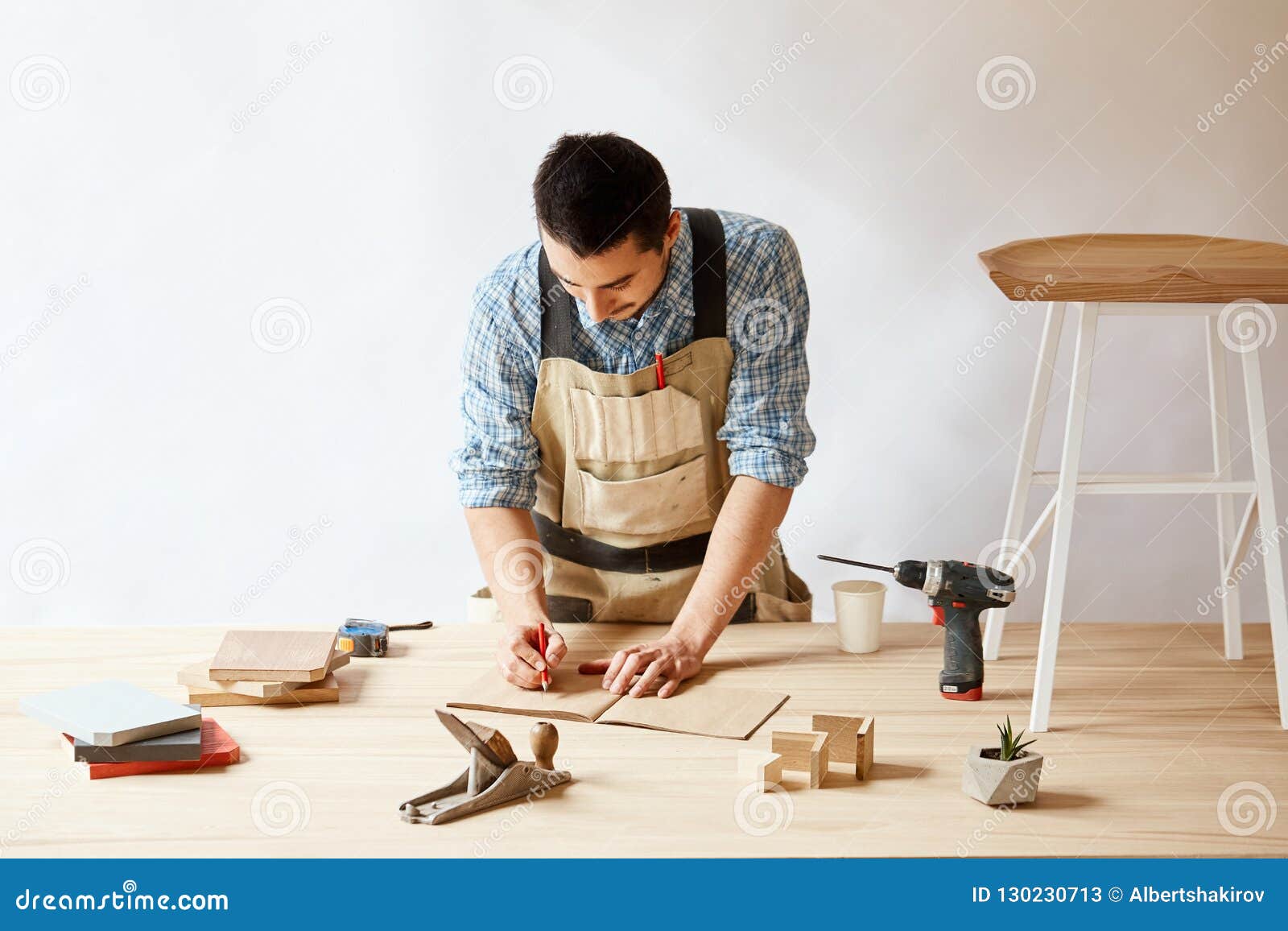 Carpenter Man Making Draft Plan Using Pencil on the Table with Tools ...