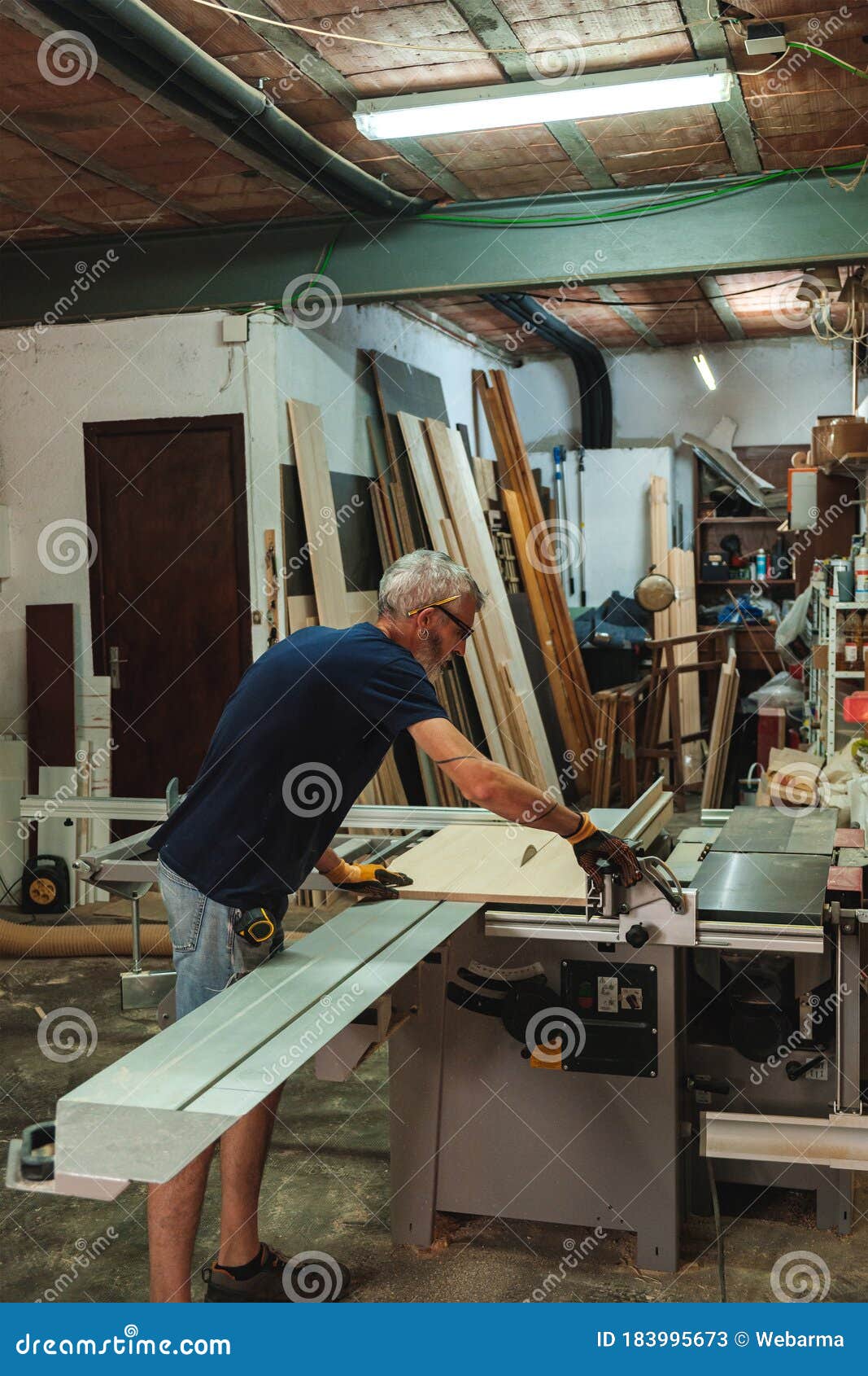 Carpenter Working with Wood on Industrial Saw Cutting Machine Stock ...