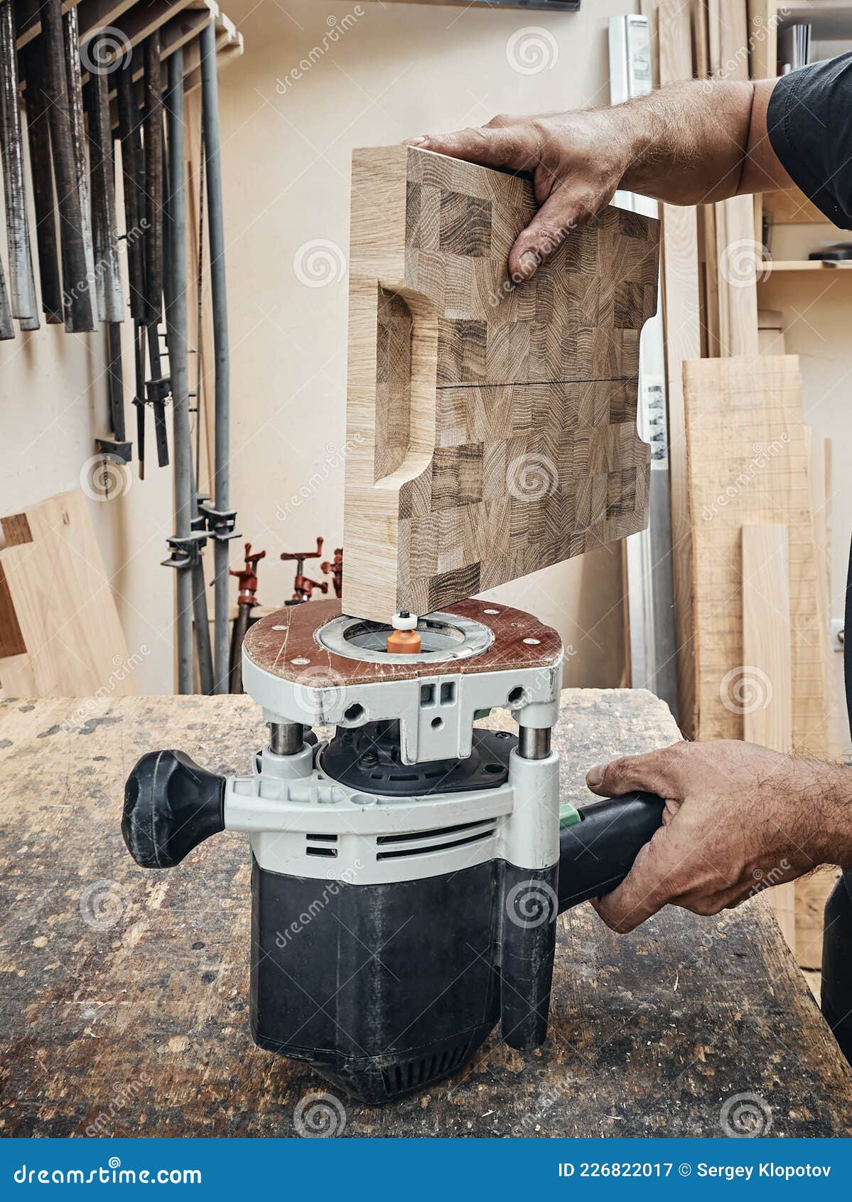 A Carpenter Works with a Hand-held Grinding Machine Stock Image - Image ...
