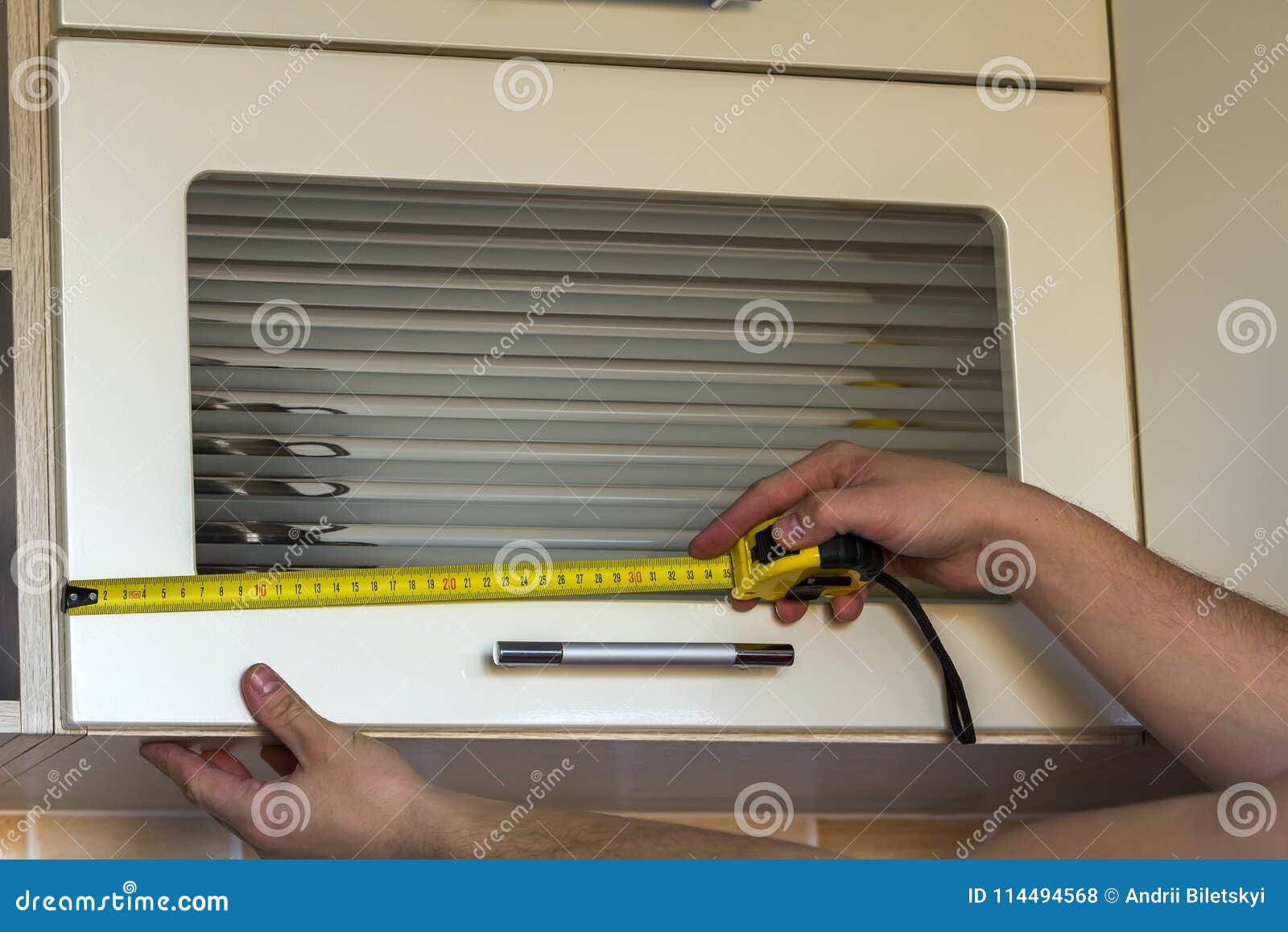 Carpenter in the Workshop Makes Measurements of the Product with a ...