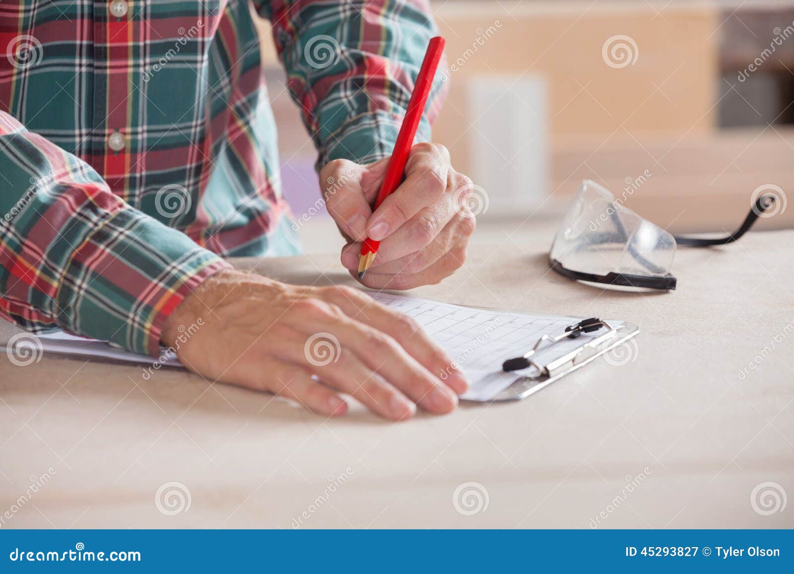 Carpenter Writing Notes on Clipboard at Table Stock Image - Image of ...