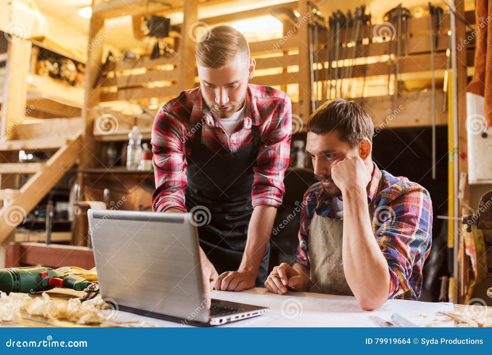 Carpenters with Laptop and Blueprint at Workshop Stock Photo - Image of ...
