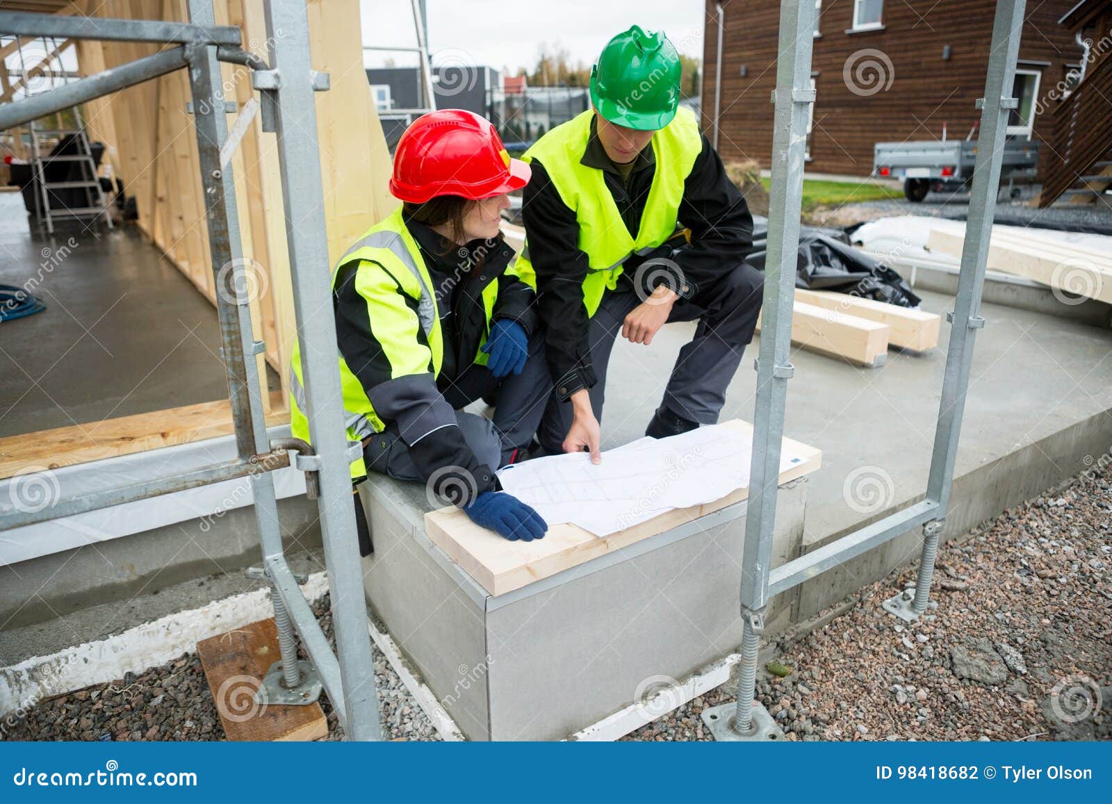 Carpenters with Plan Sitting at Construction Site Stock Photo - Image ...