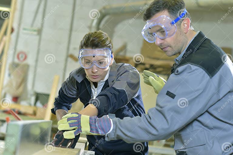 Carpentry Instructor with Trainee at Work Stock Photo - Image of gloves ...