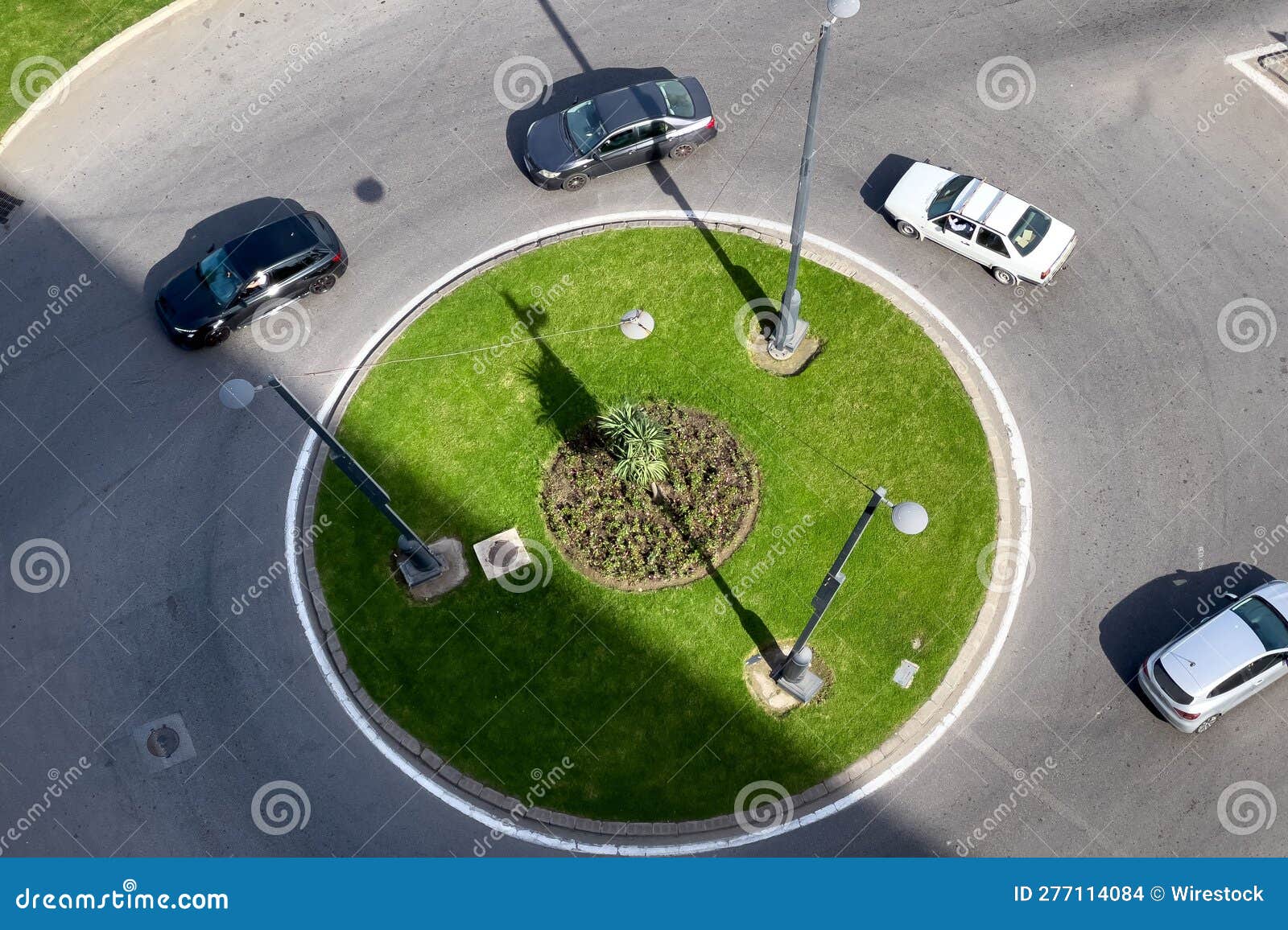 Cars Driving Around a Roundabout Stock Photo - Image of lawn, freeway ...
