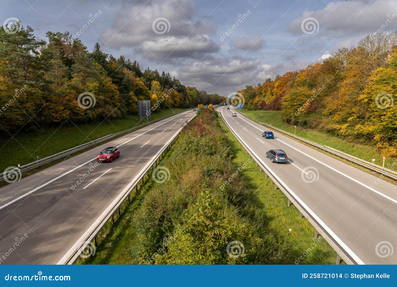 Cars are Driving Fast Over a Highway at the Fall Time, Framed by ...