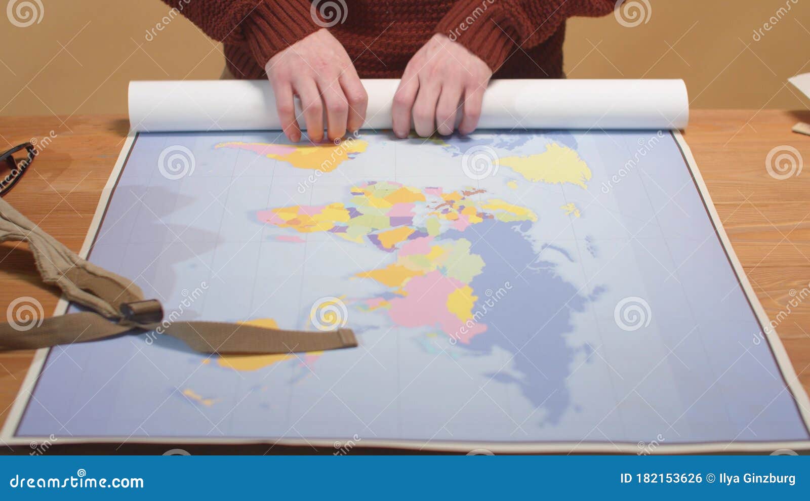 A Man Rolls a Map and Takes Out Paper and Pen Stock Photo - Image of ...