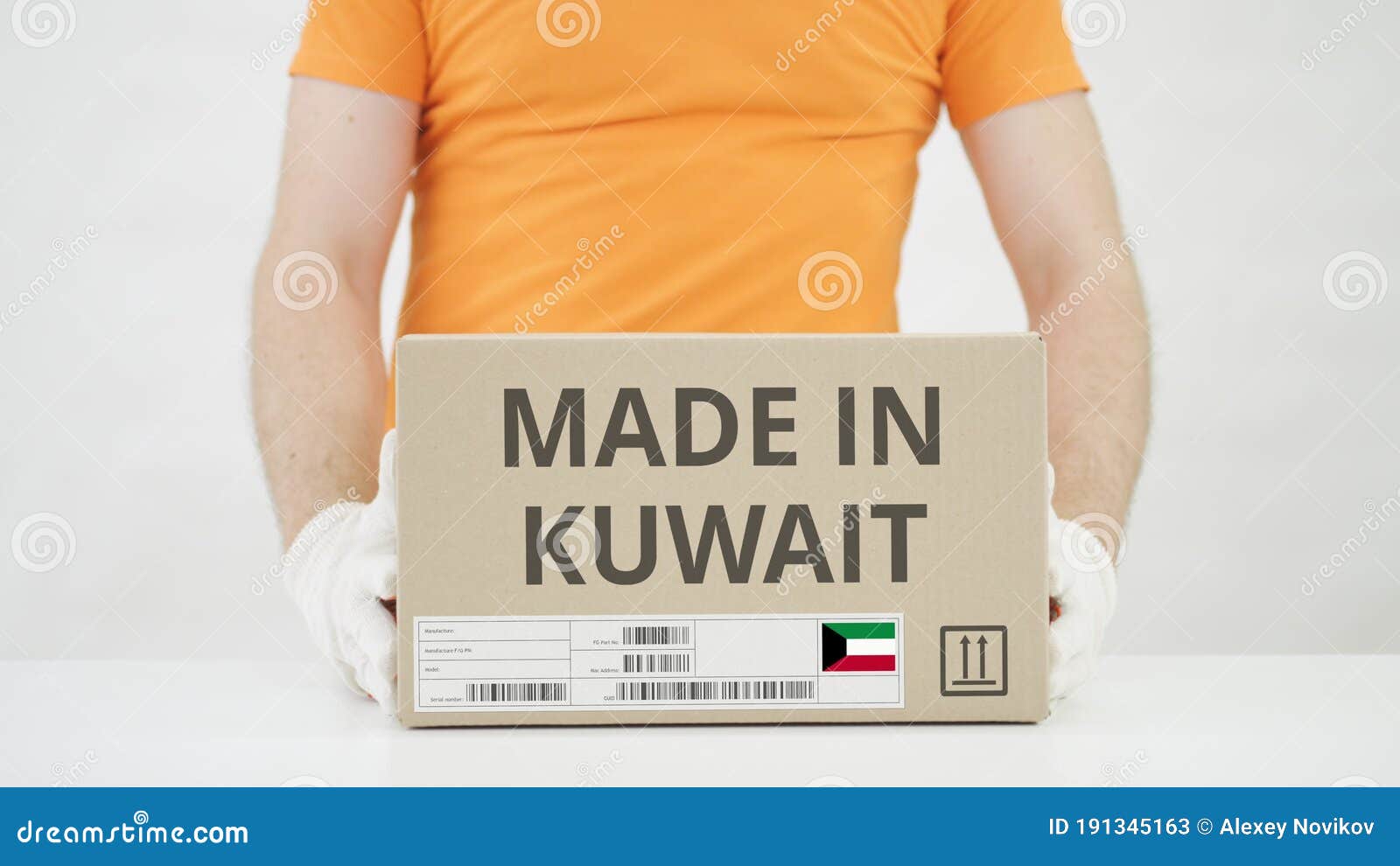 Man Puts Cardboard Box with MADE in KUWAIT Text on the Table Stock ...