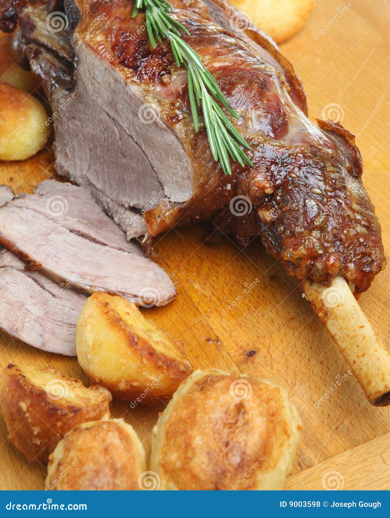 Carving Roast Leg of Lamb stock photo. Image of potatoes - 9003598