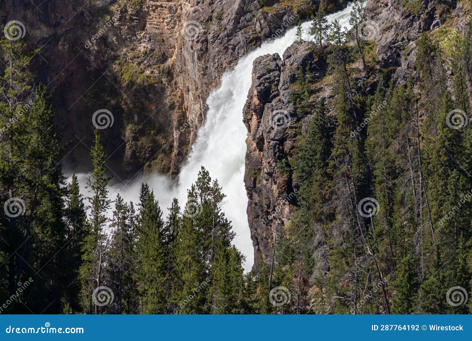A Cascading Waterfall Gliding Across a Mountainous Terrain at a Rapid ...