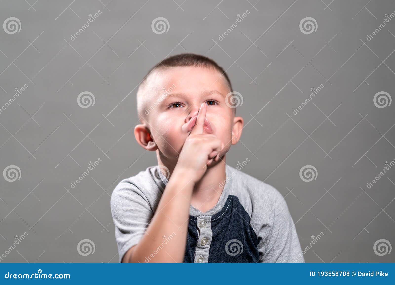 A Child Male Model, Looking Off Camera Making Shushing Motion Stock ...