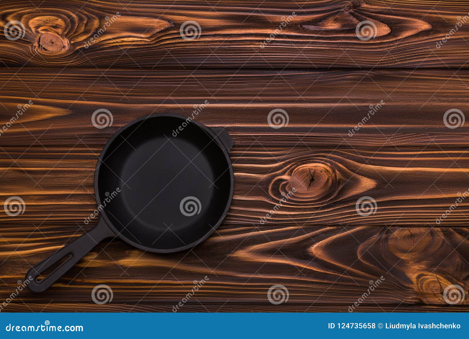 Cast Iron Frying Pan on a Wooden Background. View from Above. Kitchen ...