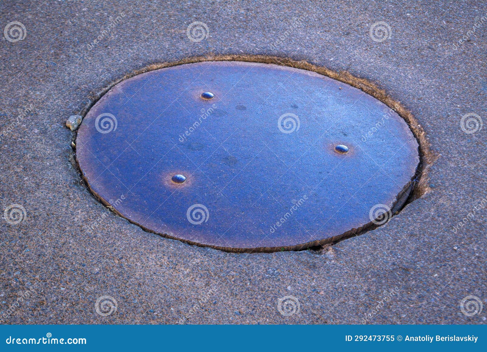 Cast-iron Manhole of the Storm Sewer System on the Road in Front of the ...