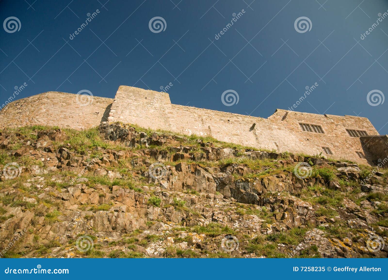Castle walls on the rocks stock image. Image of grass - 7258235