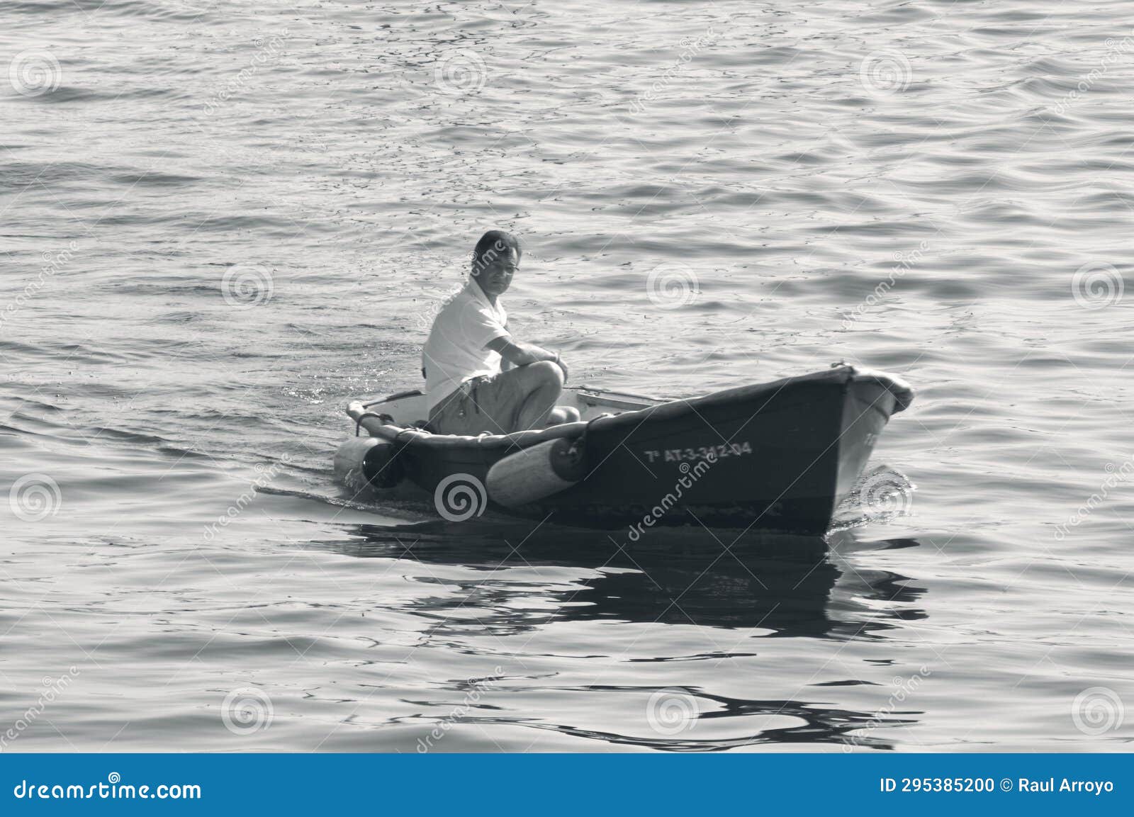 05-09-2012 Castro-Urdiales, Spain - Man Steering a Small Boat in Castro ... 05-09-2012 Castro-Urdiales, Spain - Man Steering a Small Boat in Castro ...