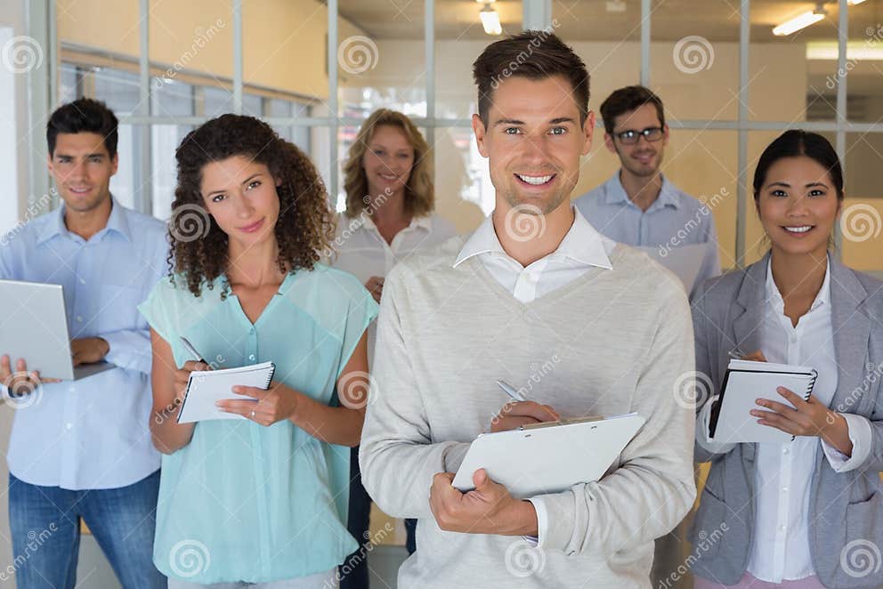 Casual Boss Standing in Front of His Team All Taking Notes Stock Photo ...