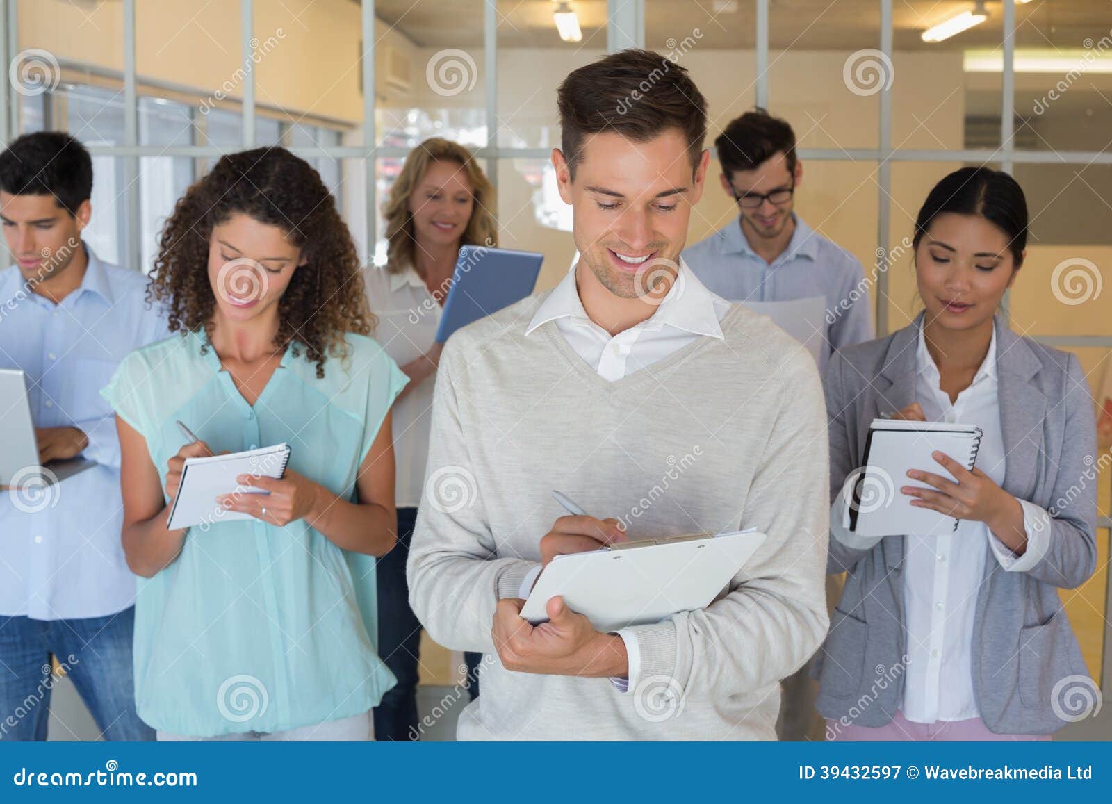 Casual Boss Standing in Front of His Team All Taking Notes Stock Image ...