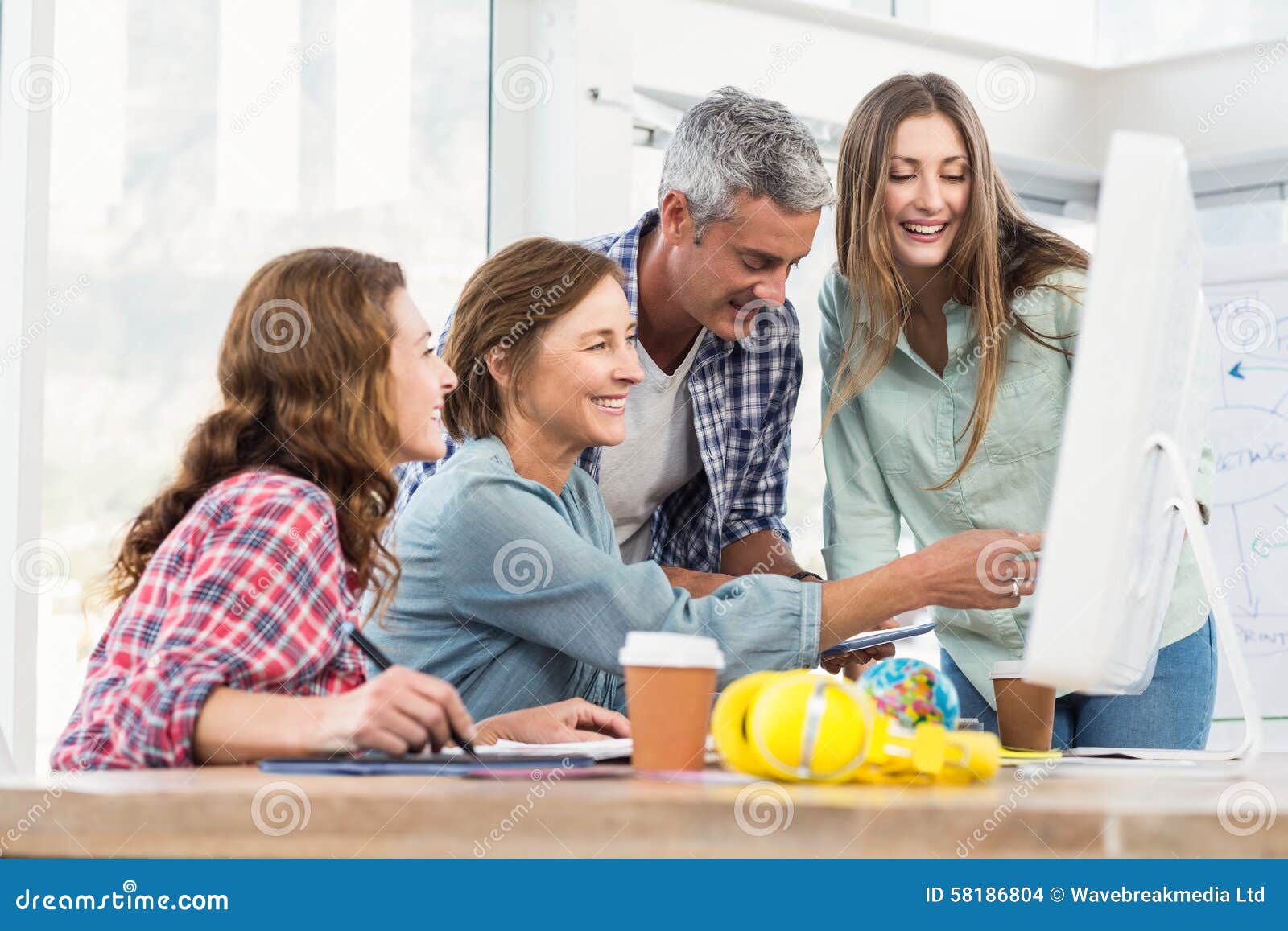Casual Business Team Having a Meeting Using a Computer Stock Photo ...