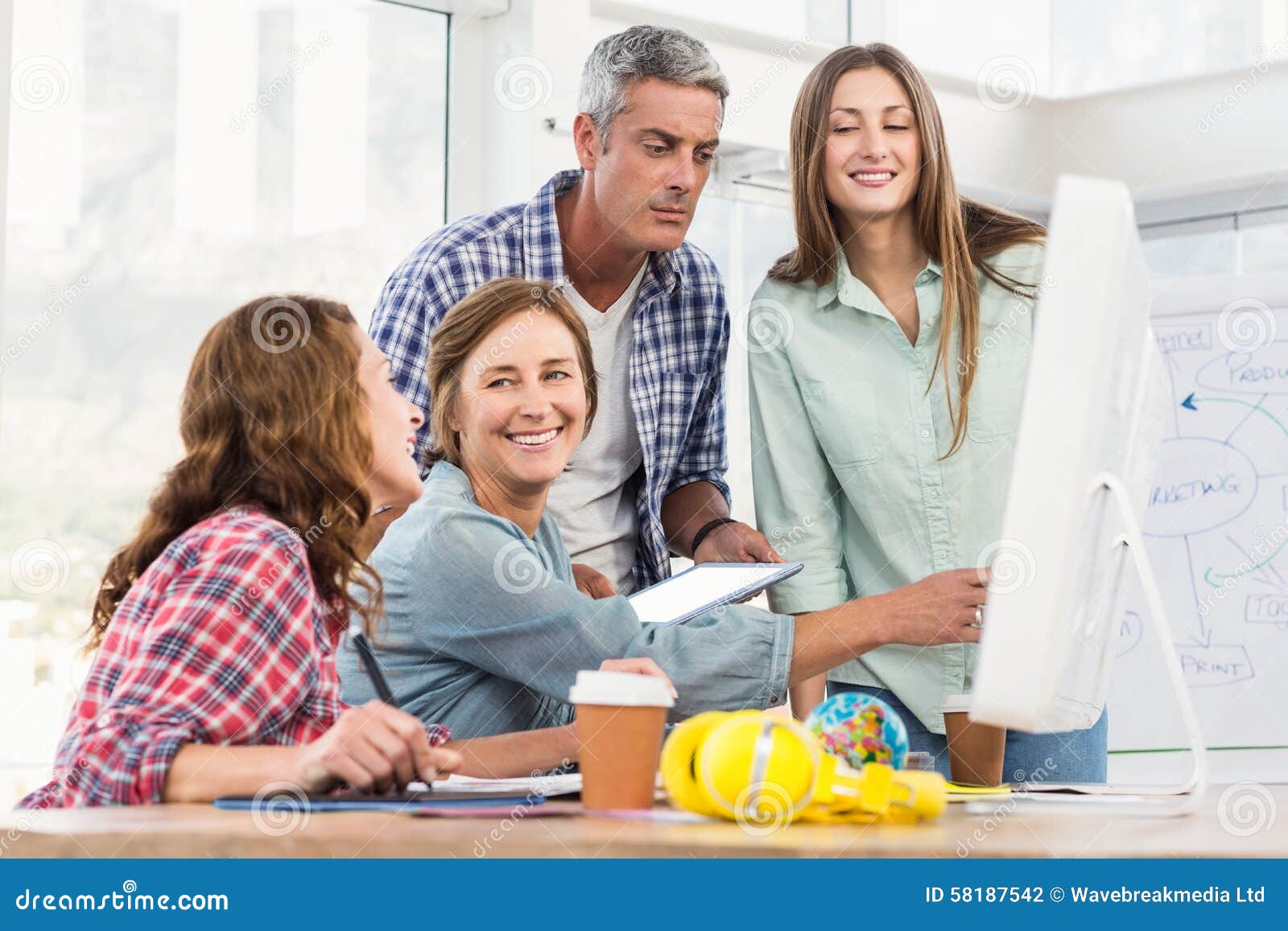 Casual Business Team Having a Meeting Using a Computer Stock Photo ...