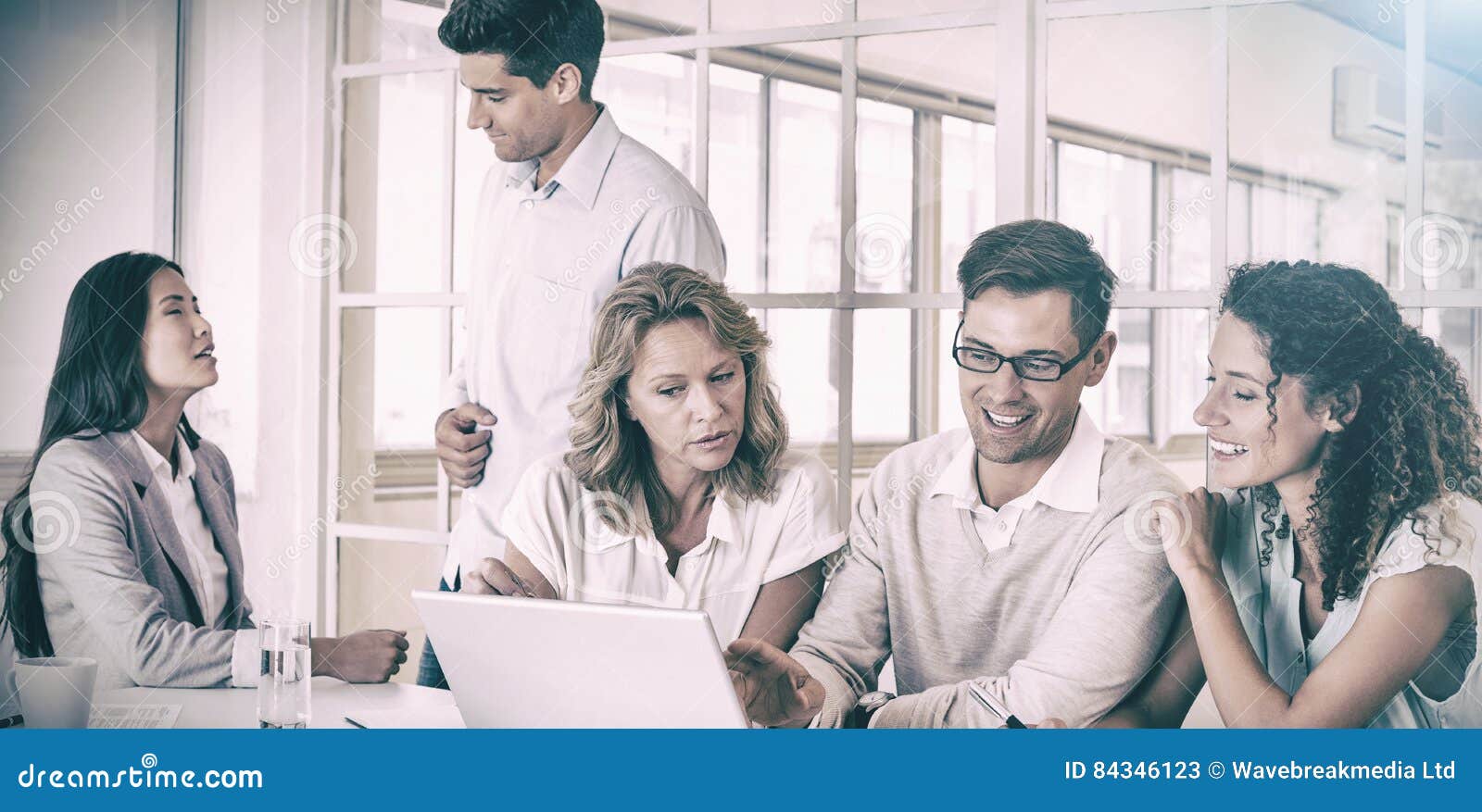 Casual Business Team Having a Meeting Using Laptop Stock Image - Image ...