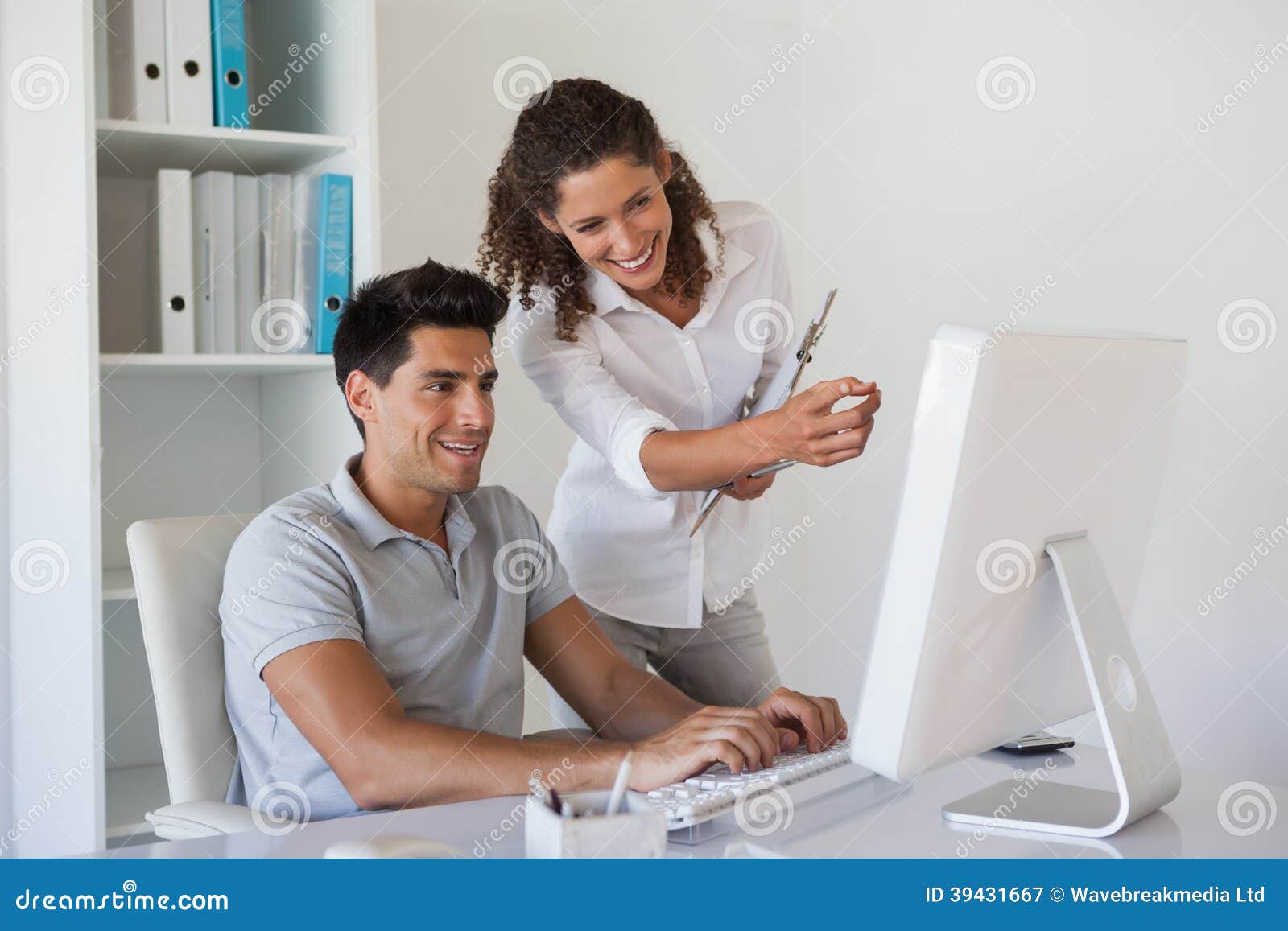 Casual Business Team Looking at Computer Together at Desk Stock Image ...