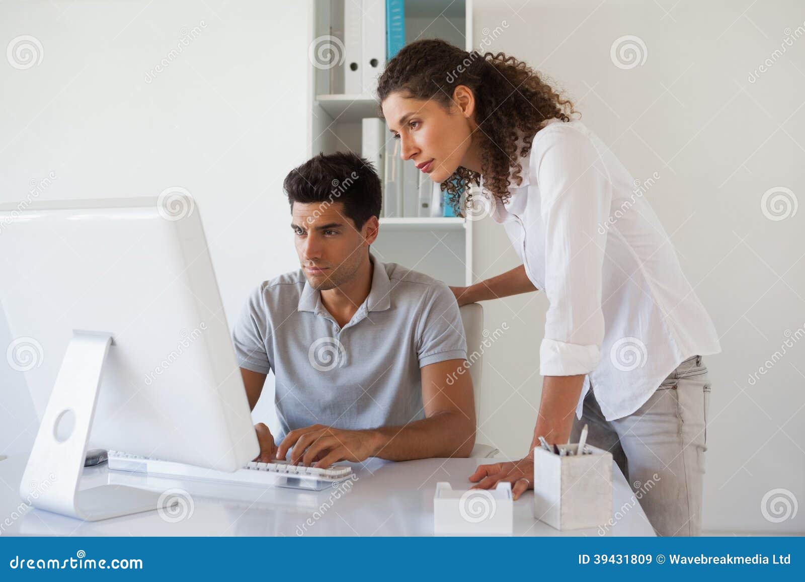 Casual Business Team Looking at Computer Together at Desk Stock Image ...