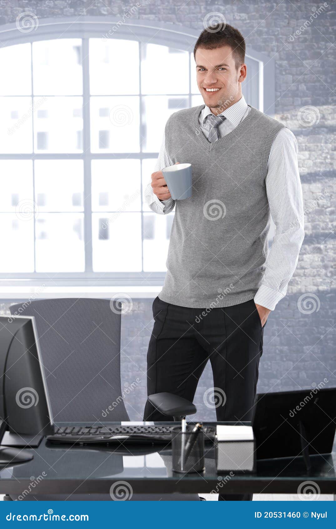 Casual Businessman Drinking Tea in Office Smiling Stock Photo - Image ...