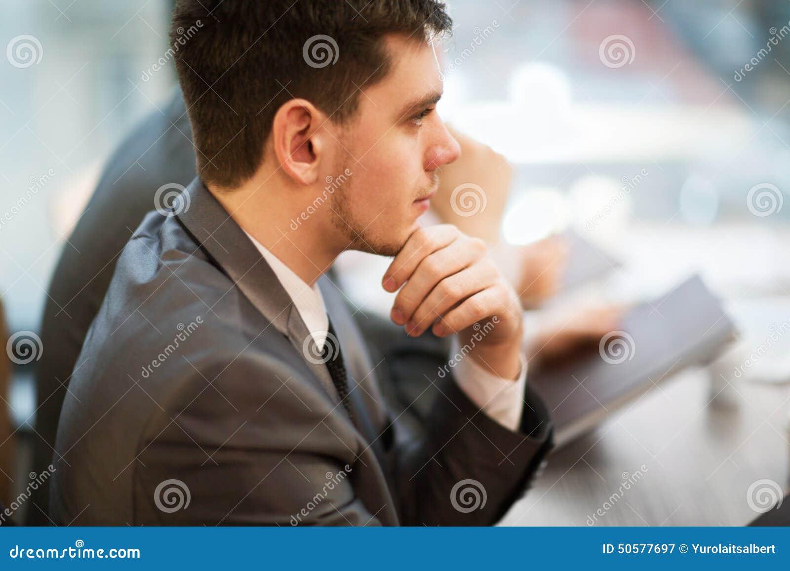 Casual Businessman Thinking with Team Behind Him Stock Image - Image of ...
