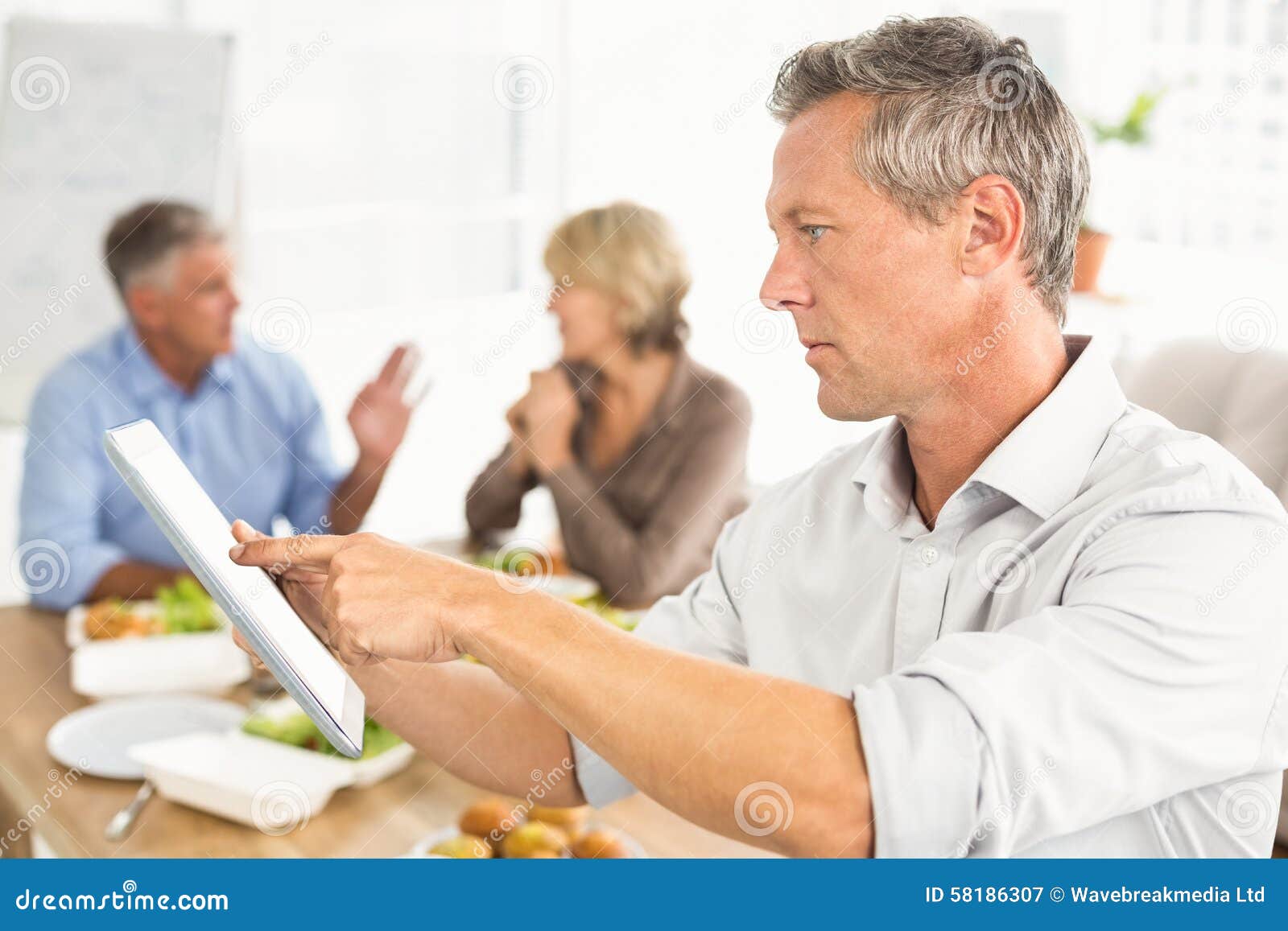 Casual Businessman Using Tablet at Lunch Stock Image - Image of ...