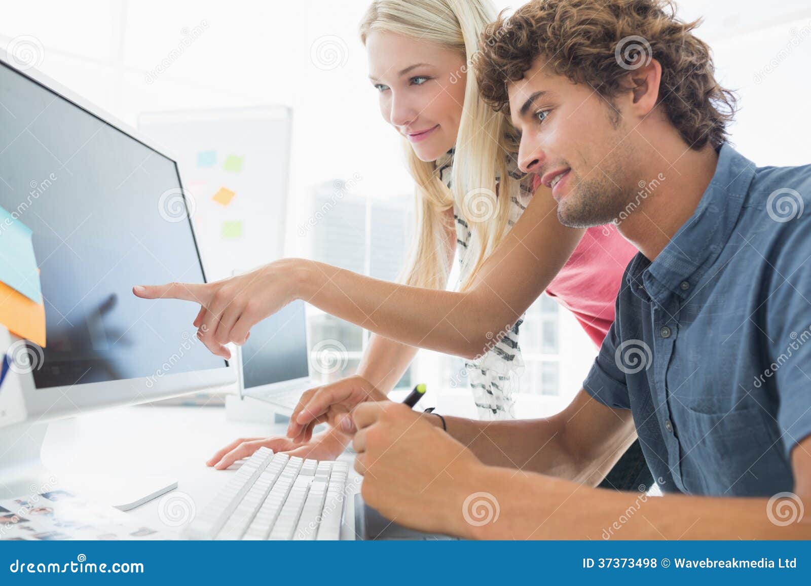 Casual Couple Using Computer in Office Stock Photo - Image of technolo ...
