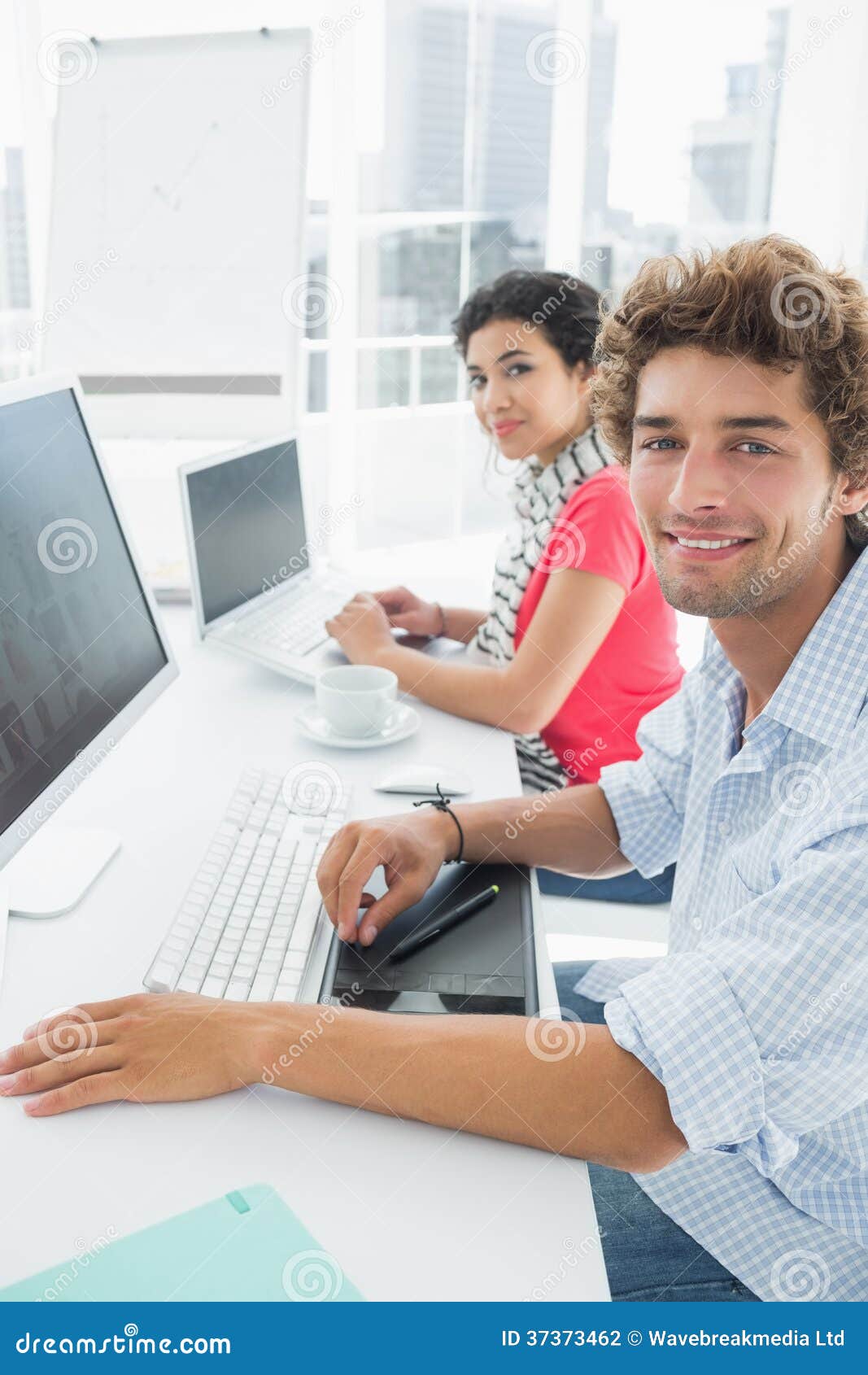 Casual Couple Using Computers in Office Stock Photo - Image of ...